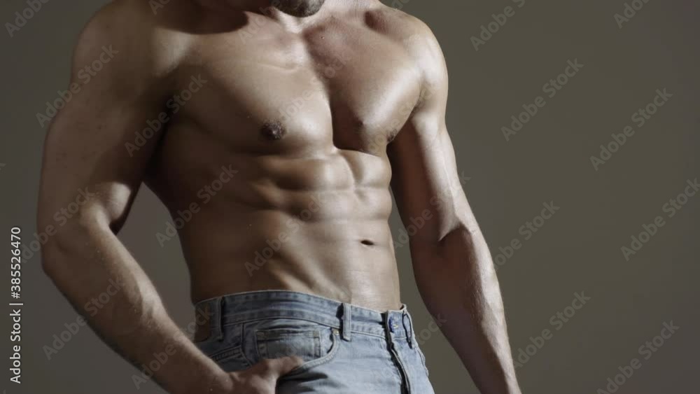Strong man showing his perfect body on black background. Mens fashion ...