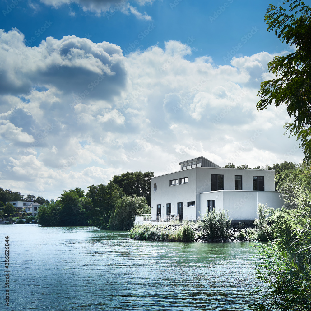 Modern white residential house on the waterfront of a crack pool with ...
