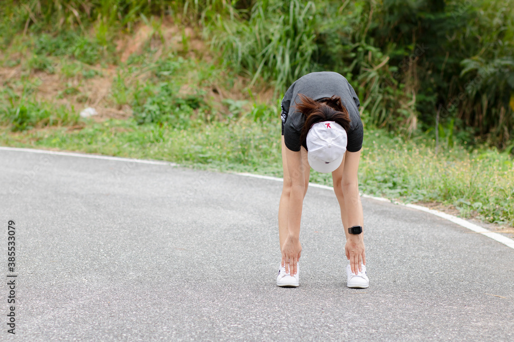 stooping forward. woman in sportswear, doing head-to-knee pose ...