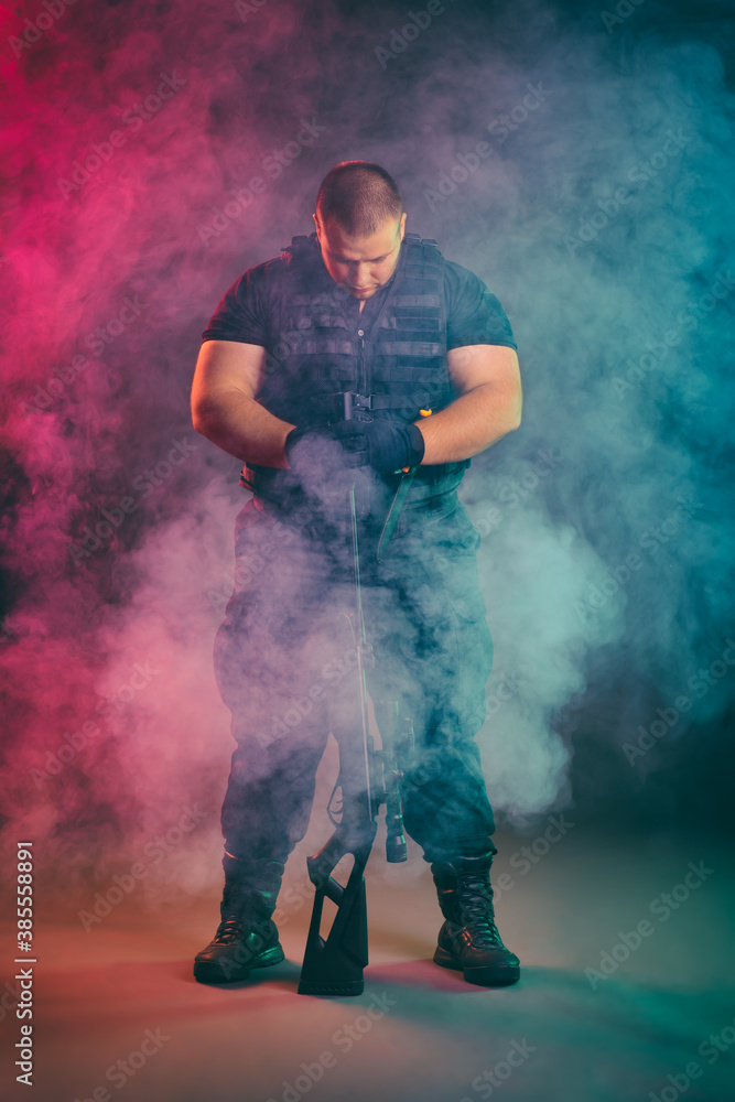 Soldier comes out of the smoke on the battlefield. The concept of ...