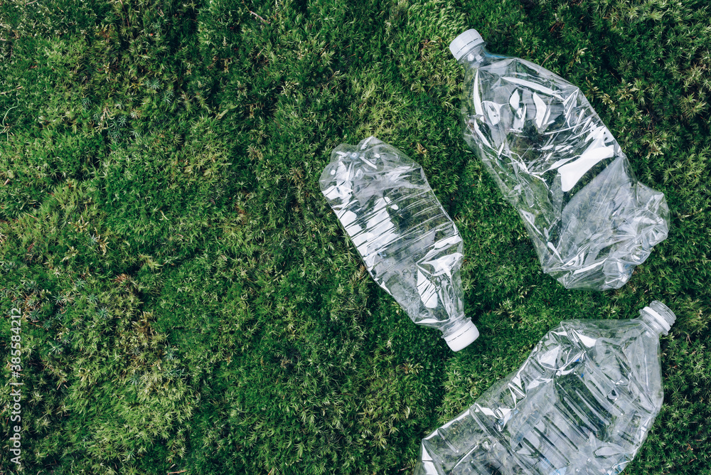 Plastic bottles on green moss background. Recycle plastic, waste ...