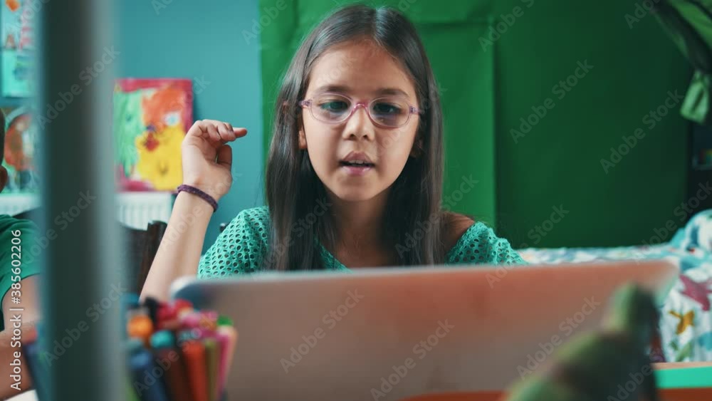 Beautiful kid hacker girl finishing programming project on laptop doing ...