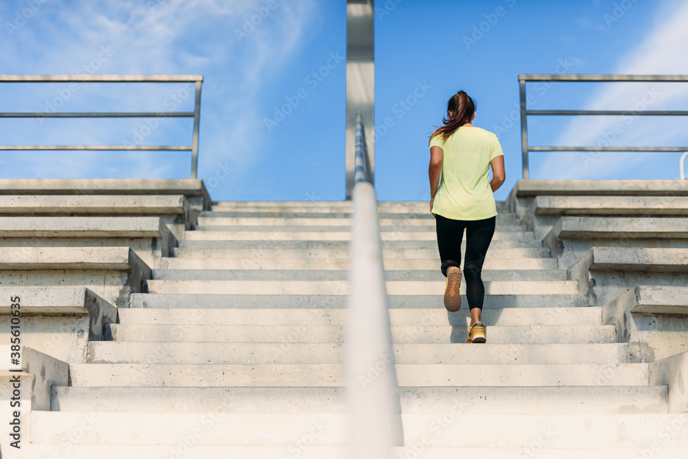 Young female athlete doing run up at local stadium Stock Photo | Adobe ...