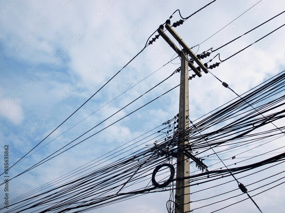 High voltage transmission lines on concrete poles. Below are low ...