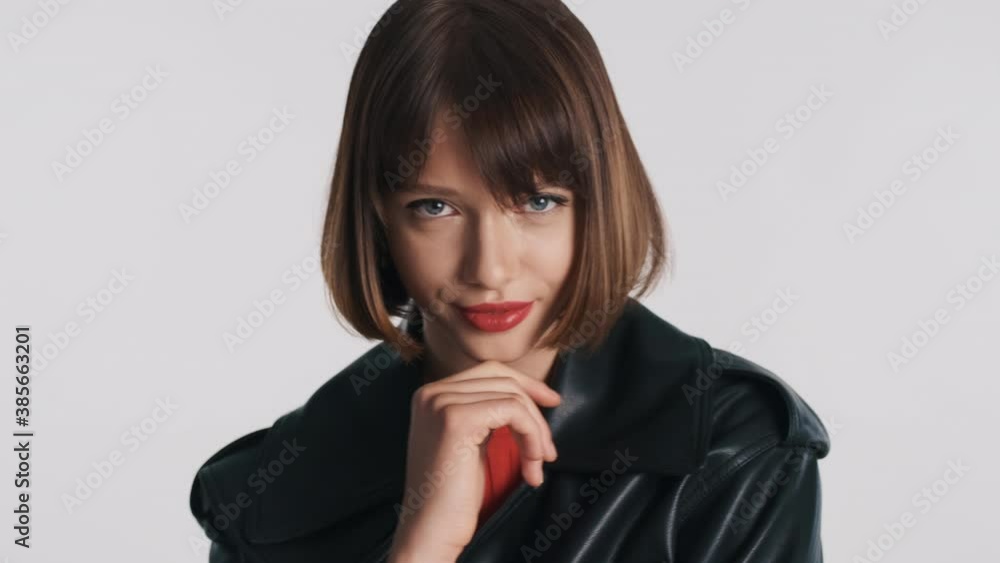 Beautiful cute girl with bob hair and red lips posing on camera with ...