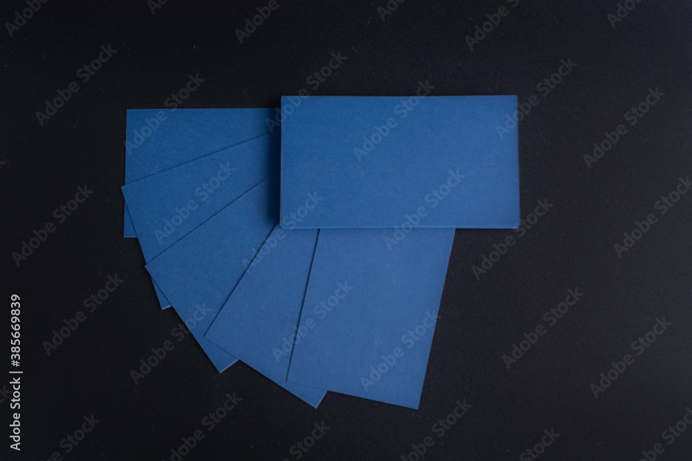Blue blank glossy textured stack of business cards on black paper ...