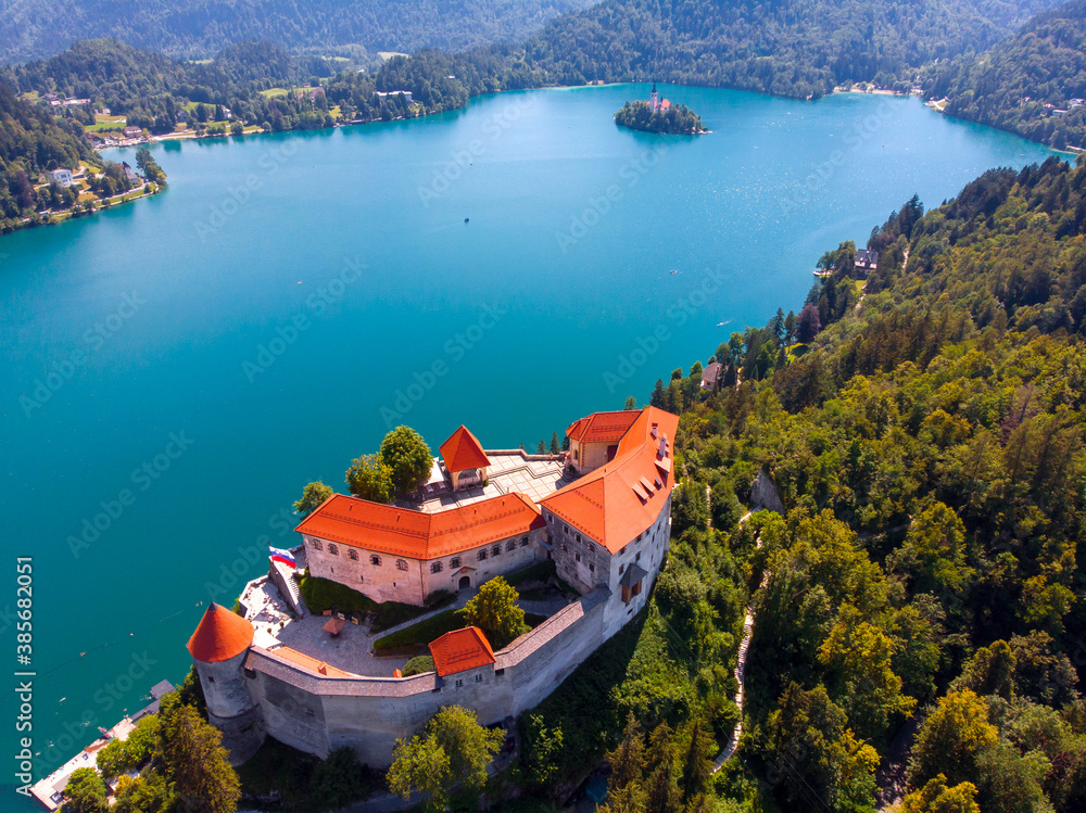 Aerial view of Lake Bled in the foreground with the castle in beautiful ...