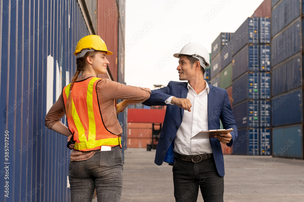 Dock worker greeting each other with elbow bump to avoid the spread of ...