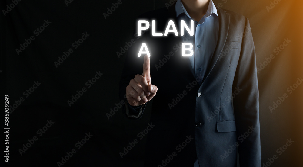 Businessman in a suit chooses options for plan development, Plan A ...