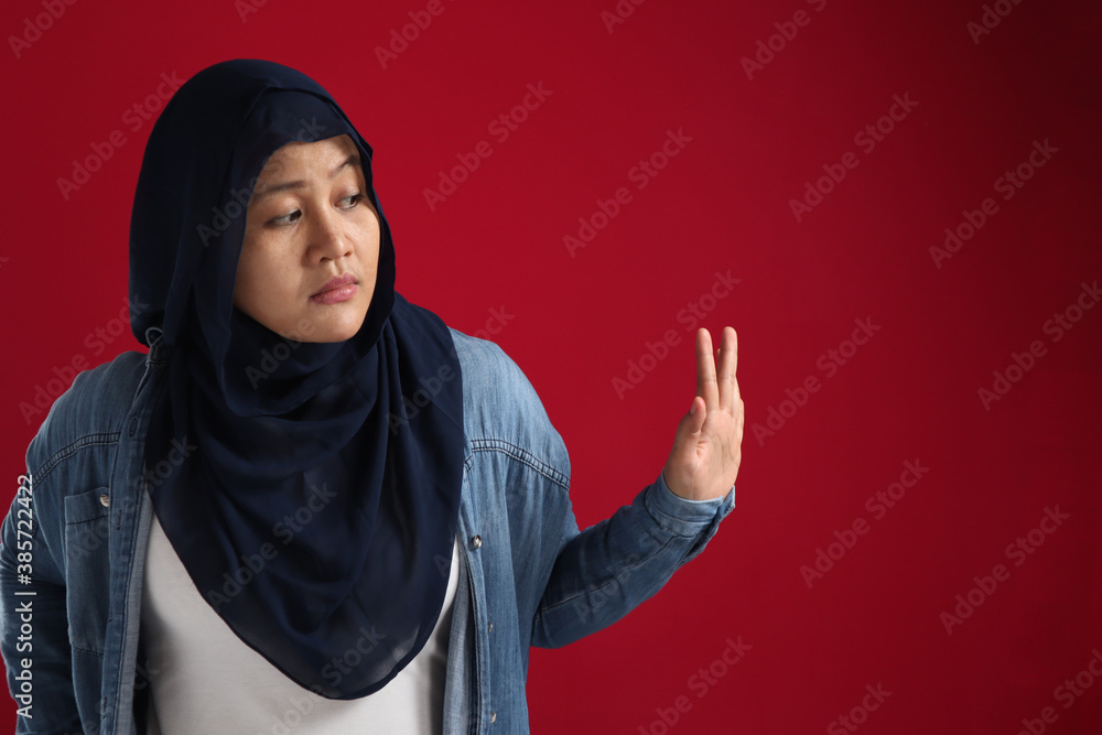 Asian Muslim Woman Wearing Hijab Rejecting Avoiding Something From The