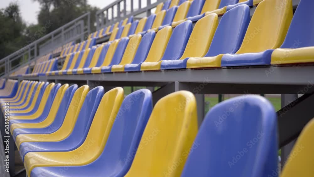 4k, Empty Rows of Plastic Seats at Stadium. Yellow and Blue Seats on ...