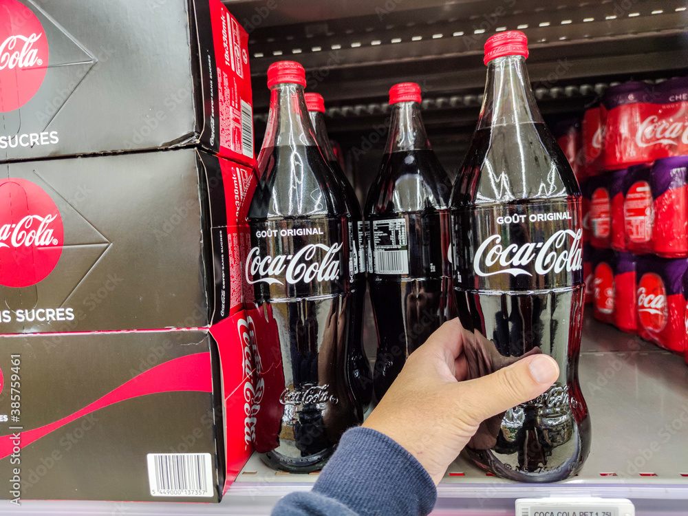 Man hand buying Original Coca Cola soft drink on French supermarket ...