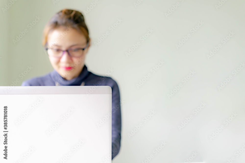 Blurry Smiling young asian businesswoman using computer at home office ...