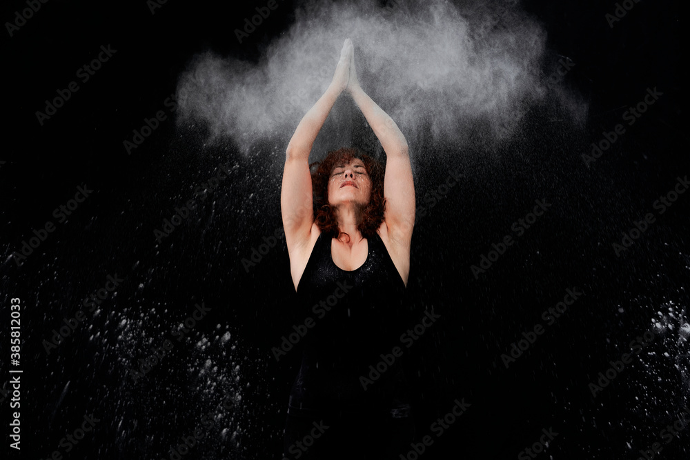 Woman clapping over head with white dust against black background Stock ...