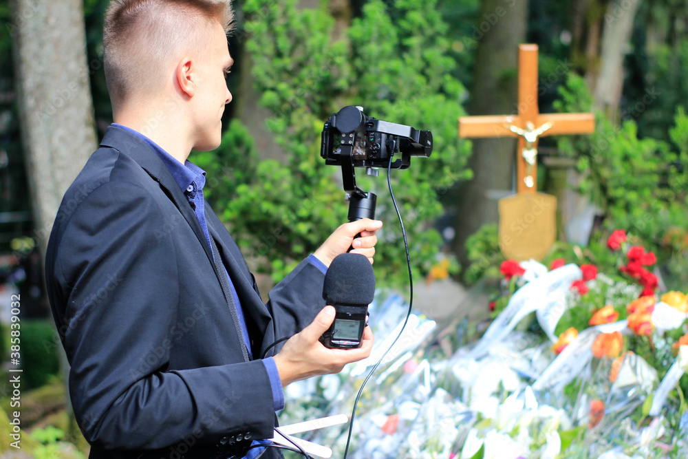 The professional man transmitting the funeral live. Funeral recording ...