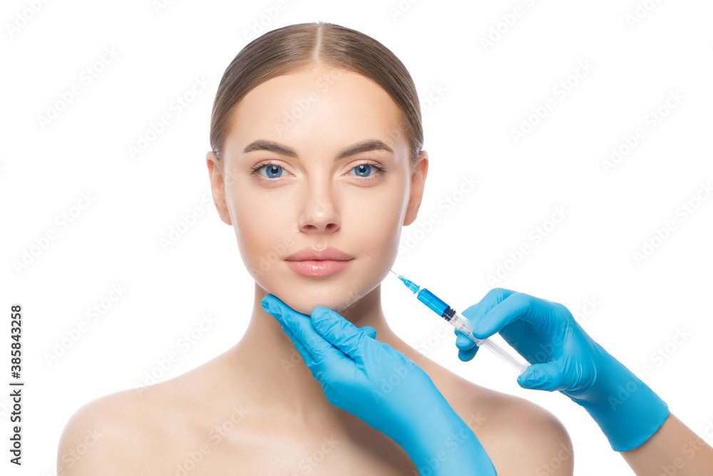 Young woman in beauty clinic, ready for filler injection into cheek to ...
