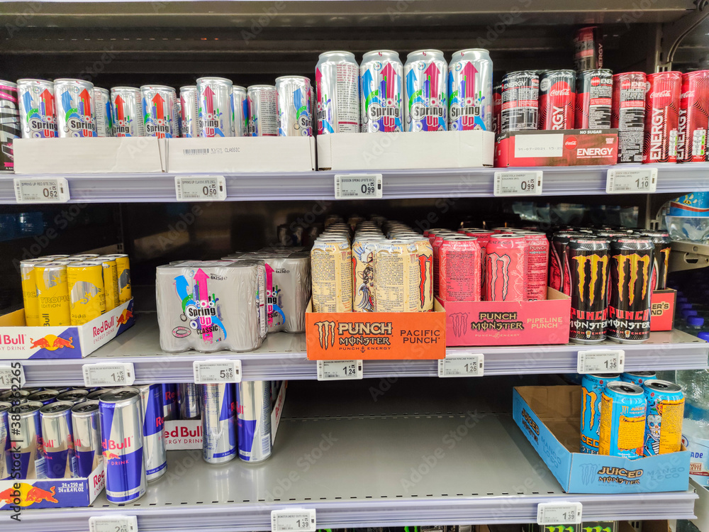 Varied range of energy drink cans with leading brands such as red bull ...