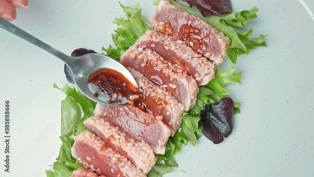Arranging in a serving plate Seared Tuna with decorative vegetables in ...