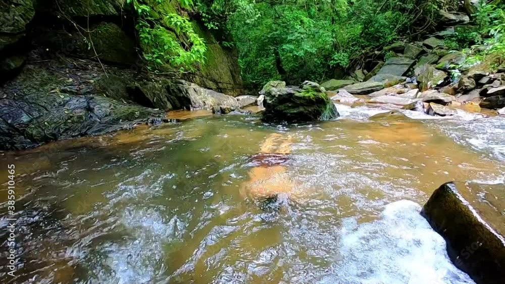 man meditating underwater in the waterfall and enjoying in nature at ...
