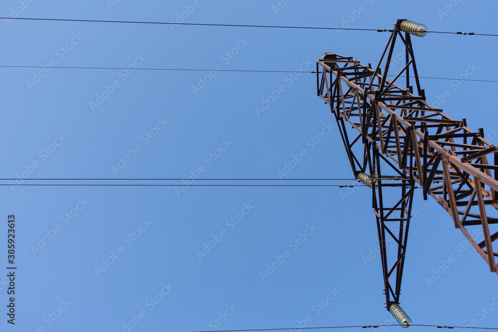 Steel structure of a power line steel tower. Tower is against clear ...