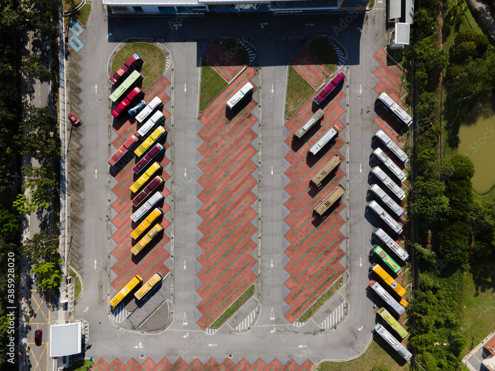 An aerial top down view of a bus depot with numbers of buses park ... An aerial top down view of a bus depot with numbers of buses park ...