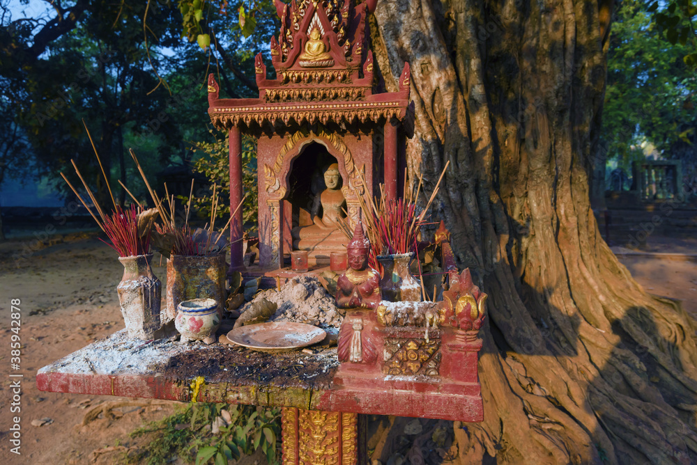 banyan tree and spirit house in the courtyard of the Bakong temple ...