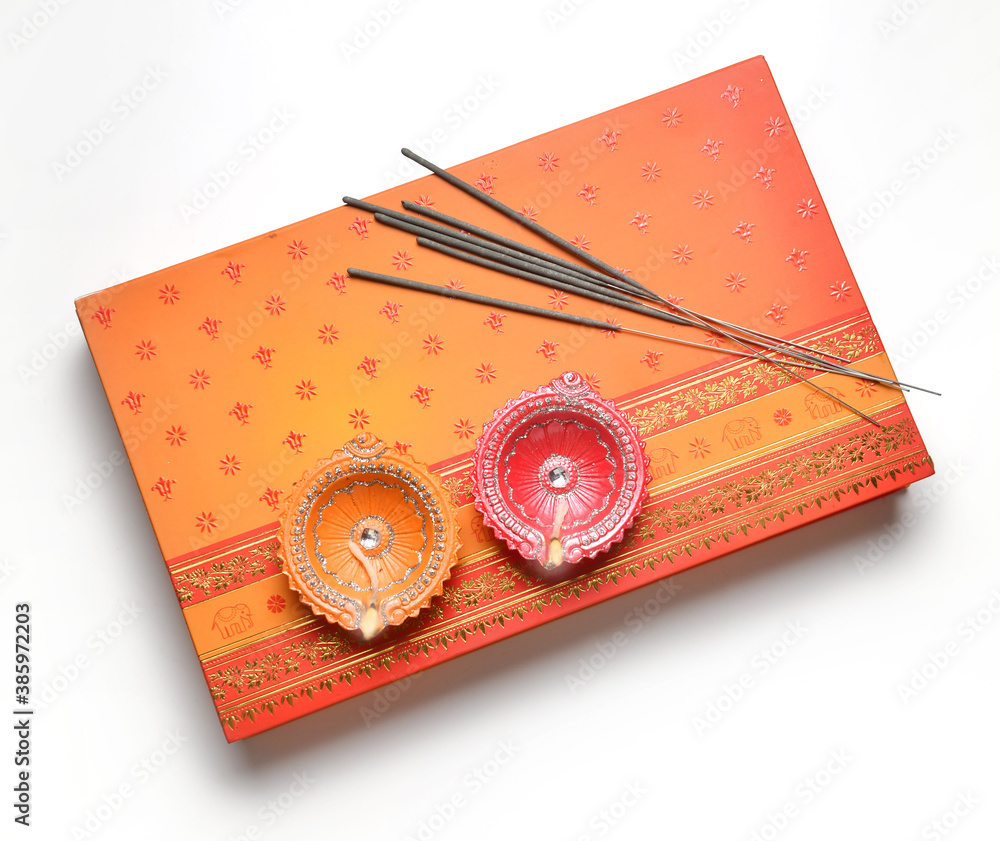 Isolated Diwali festive gift box with earthen lamps and sparklers. A ...