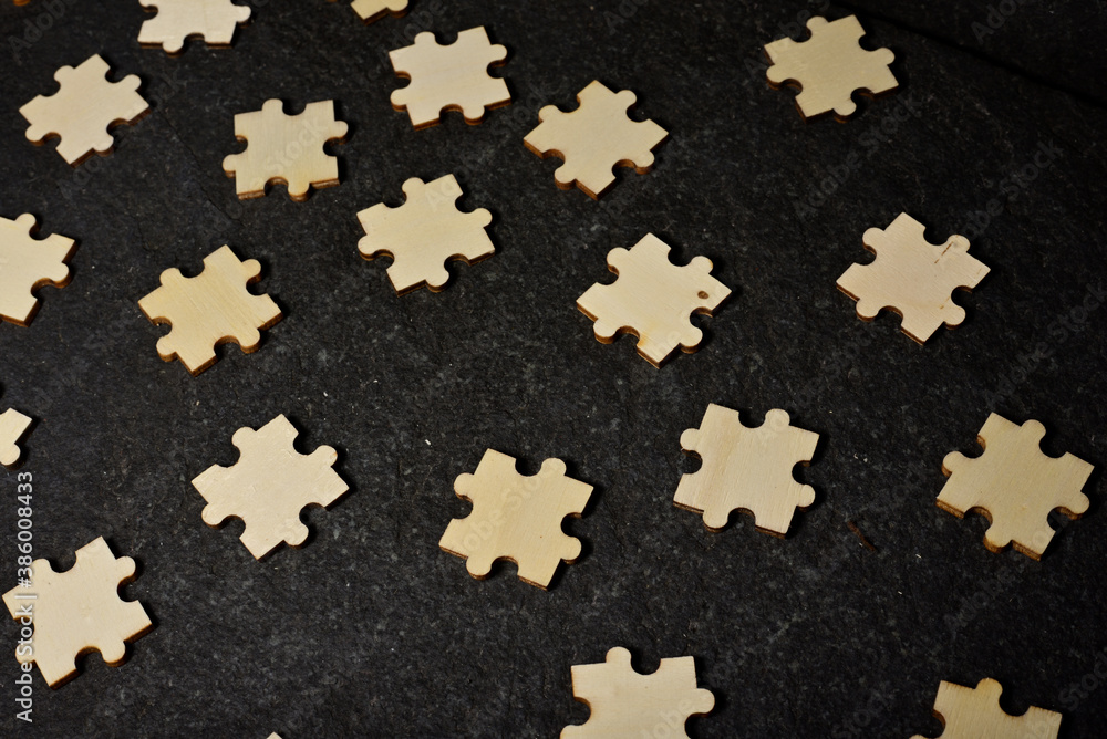 Chaos and confusion: detail of wooden jigsaw puzzle pieces mixed on ...