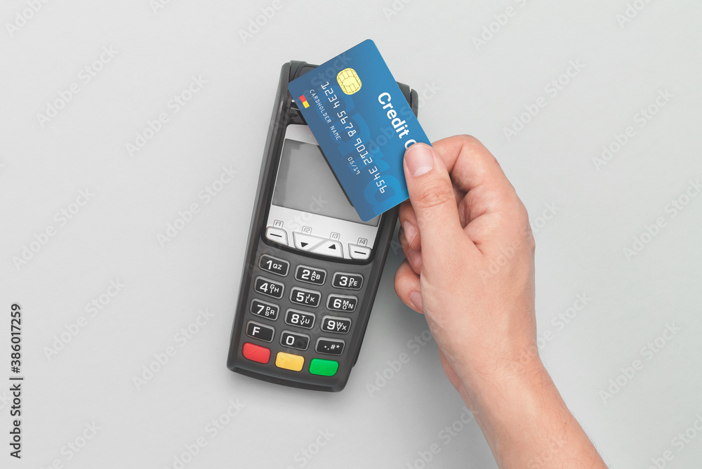 Man using credit card and payment terminal Stock Photo | Adobe Stock