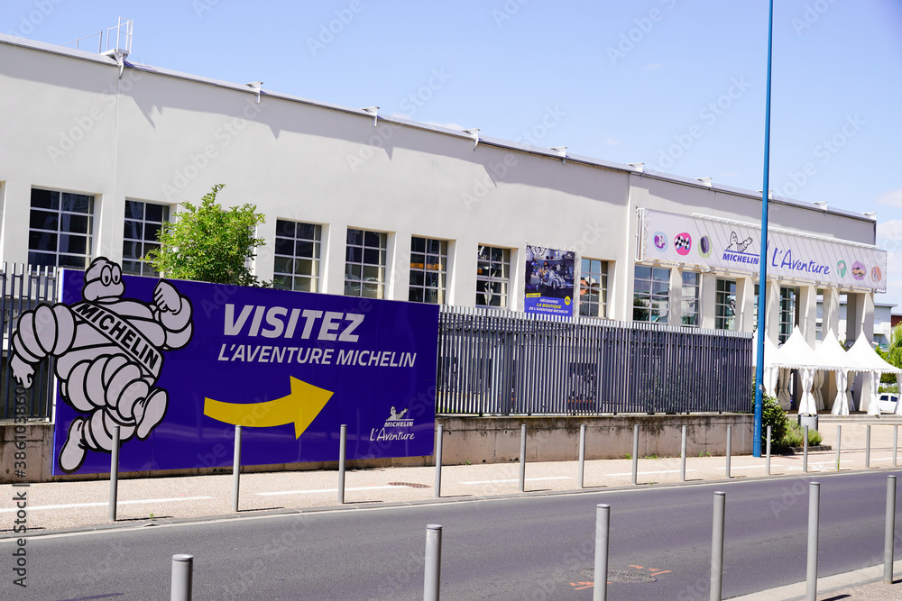 Michelin l'aventure bibendum with arrow logo sign and text front of ...
