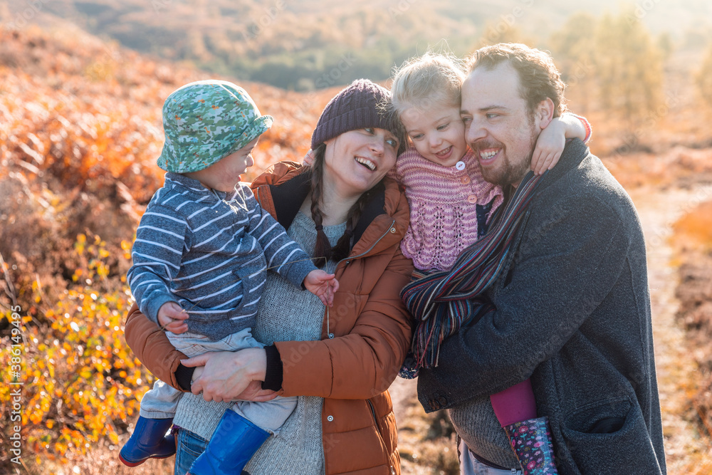 Foto Stock Happy family portrait embracing together on a sunny autumn ...
