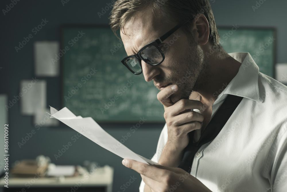 Young mathematician studying in his office and reading papers Stock ...