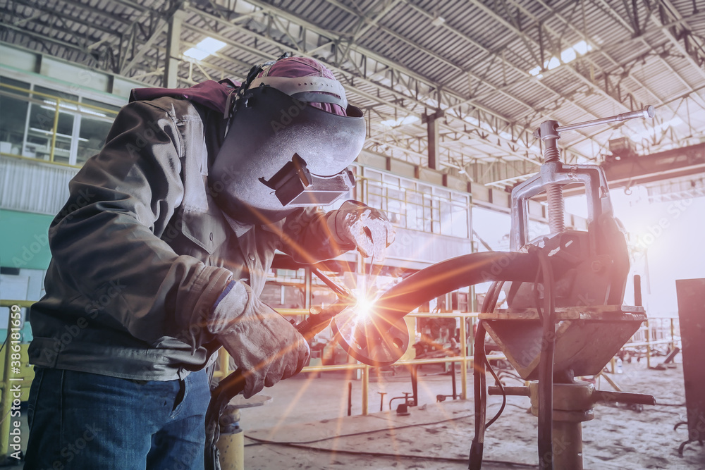 Industrial Worker at the factory welding process close up using Tig ...