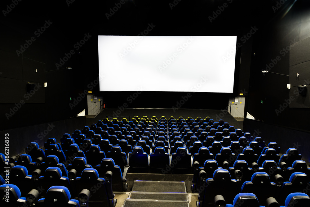 Cinema theater interior with screen and blue seats. Wide shot view from ...