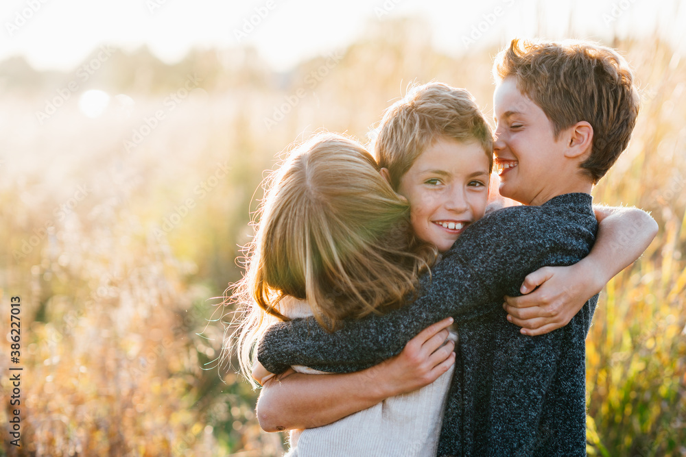 Portrait of young siblings hugging each other Stock Photo | Adobe Stock