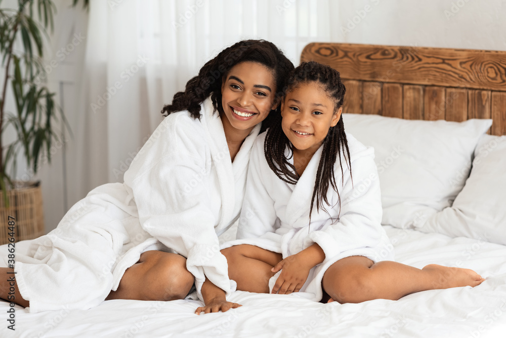 Mom And Daughter Relax. Little Black Girl And Mother Posing In Bathrobes Stock Photo | Adobe Stock