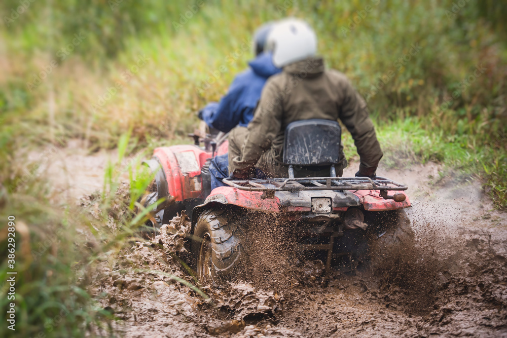 Group of riders riding atv vehicle on off road track, process of ...