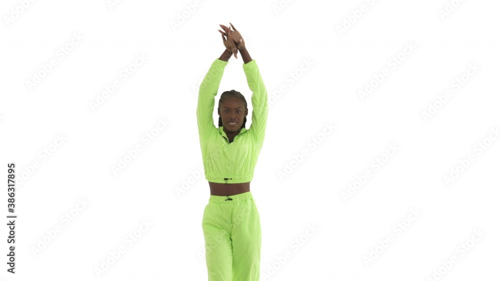 African woman dancing, swiping hand over body, twisting arms behind ...