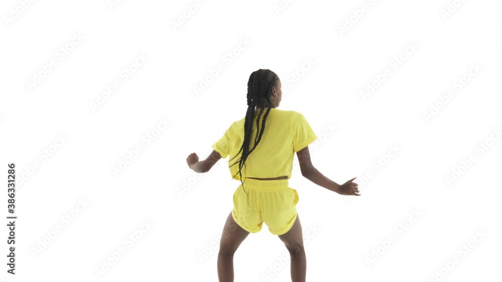 Back view of young slim African woman shaking buttocks and intensely ...