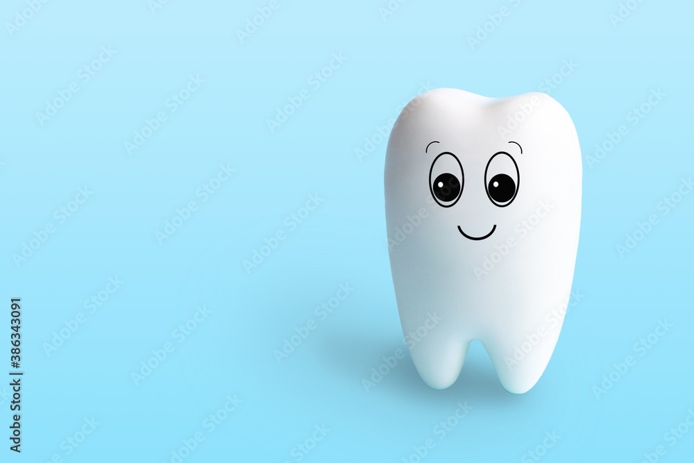 Fun toy white tooth isolated on light blue background with copy space ...