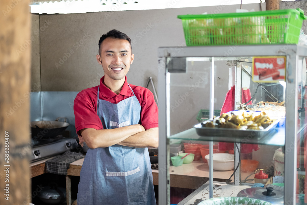 food stall seller smiling with crossed hands while looking at the ...