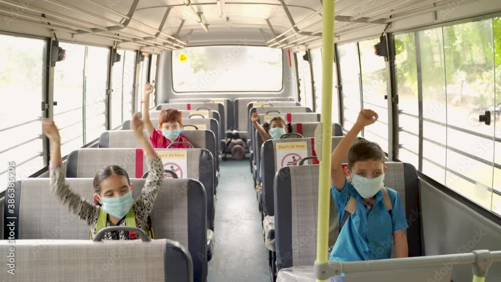 Kids in medical mask while maintaining social distancing shouting and ...