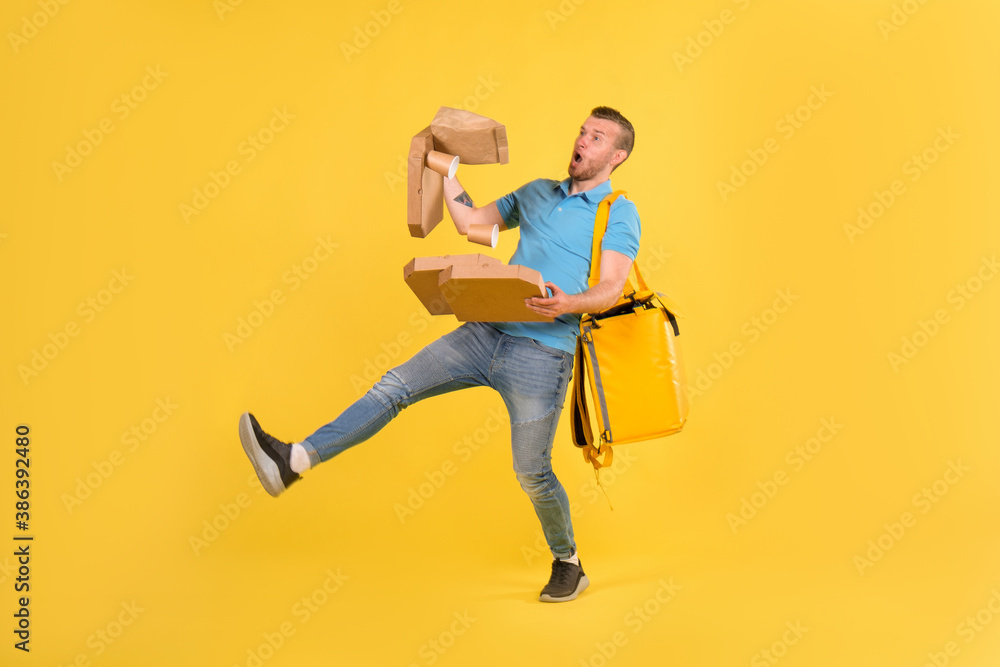 Delivery guy in blue uniform slipped and lost his balance and threw ...