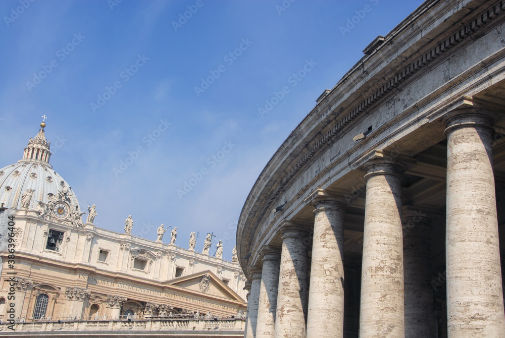 The famous colonnade of St. Peter's Square with statues in the Vatican ...