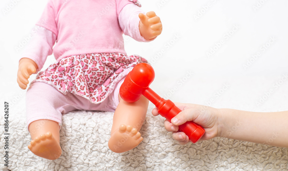 Foto de A little girl plays with a doll, and with a small neurological ...