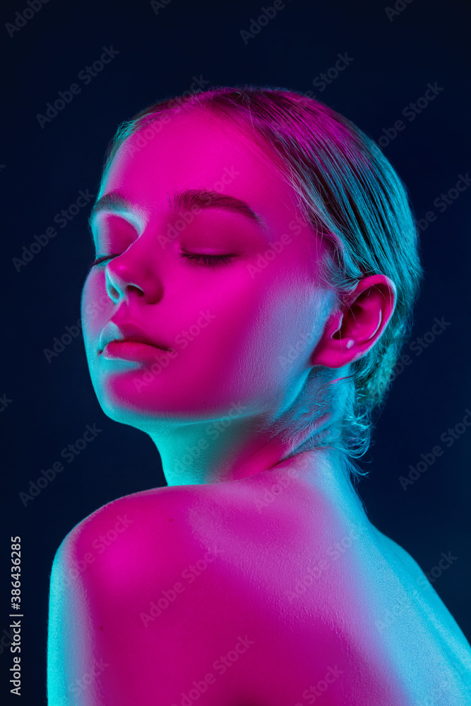 In love. Portrait of female fashion model in neon light on dark studio ...