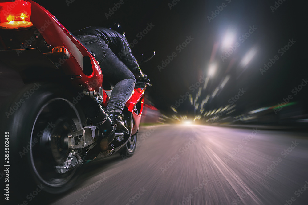 Motorbiker is driving a bike on a night road concept. Stock Photo ...