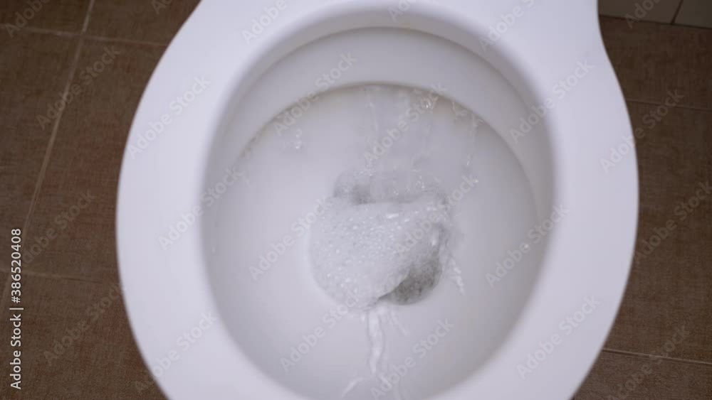 Toilet Flushed Top Down View. Water and Paper Flushing Down into Toilet ...