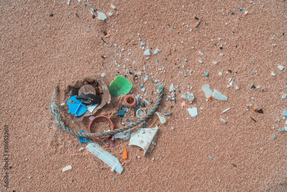 Plastic pollution on shore of beach. Ocean microplastic marine debris ...
