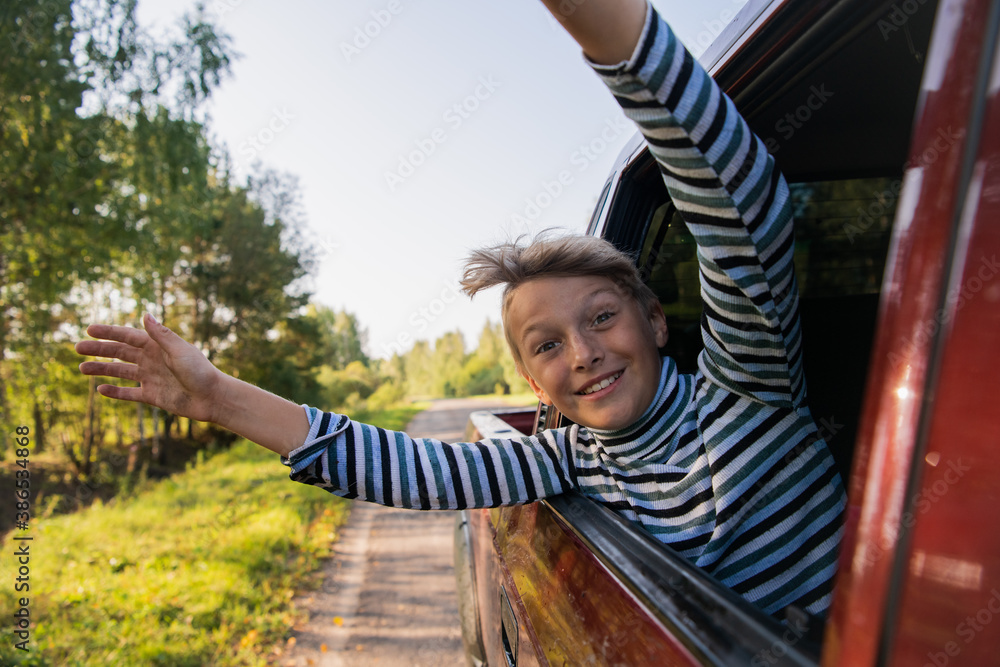 Cheerful child who is looking out of an open window of the car Stock ...
